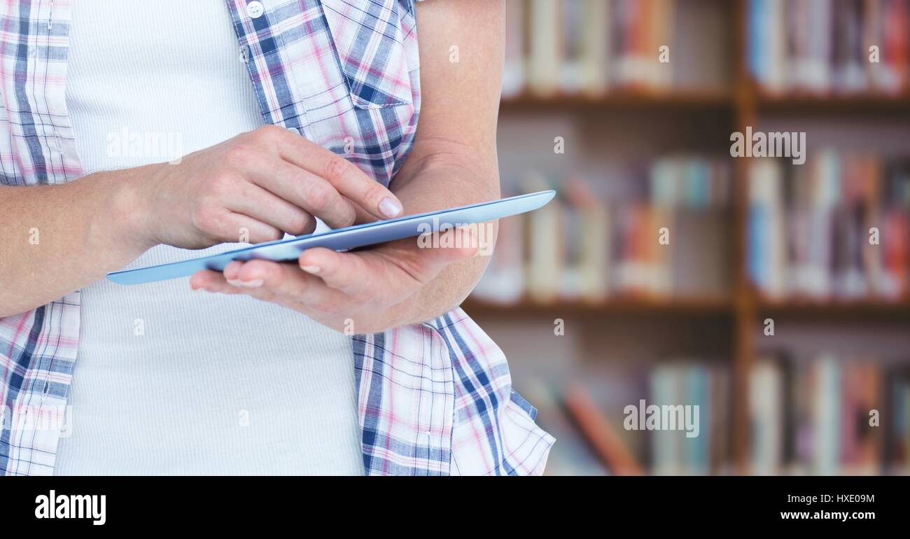 Digital composite of Womans hands touching tablet in Library Stock ...