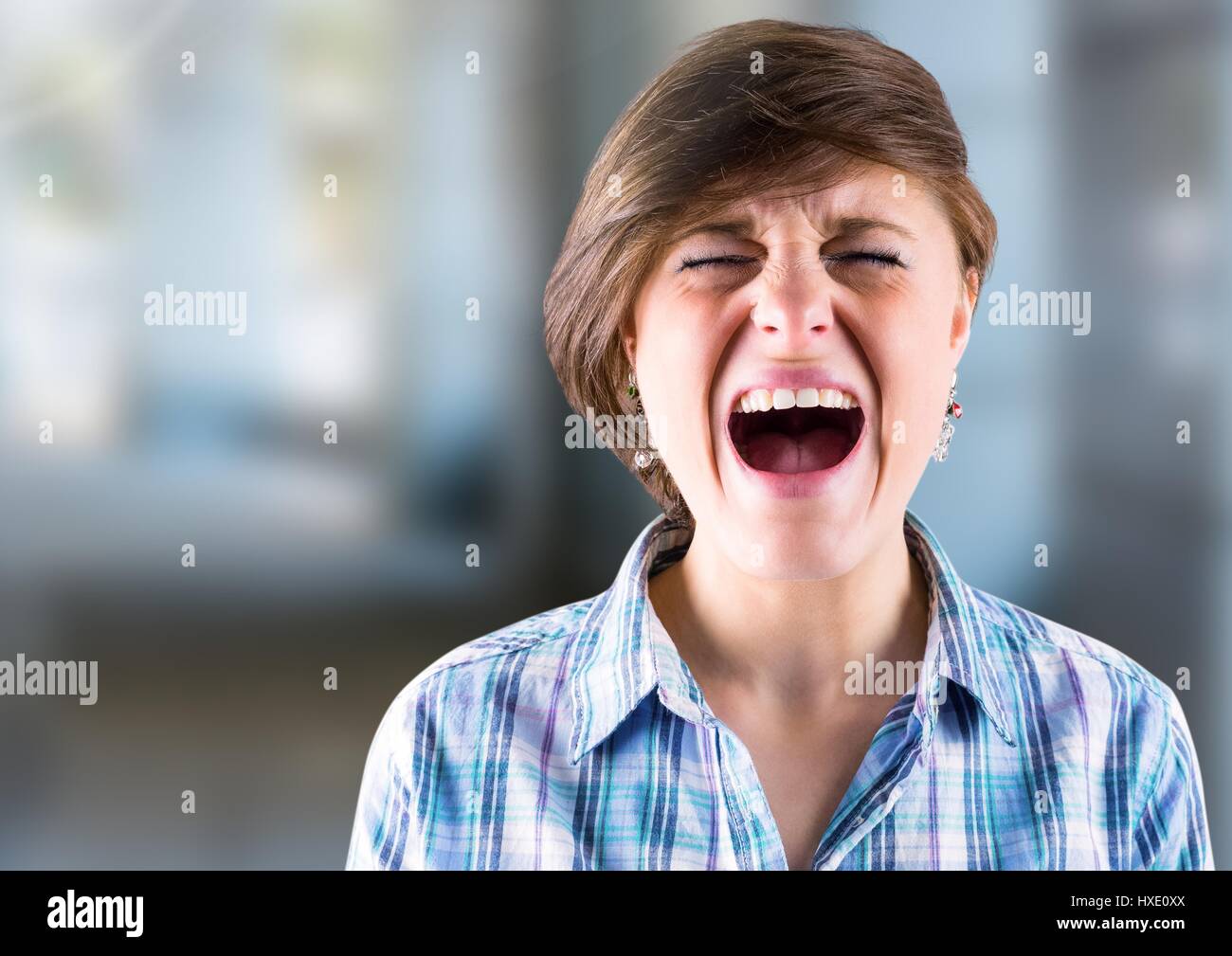 Digital composite of Stressed young woman shouting on street Stock ...