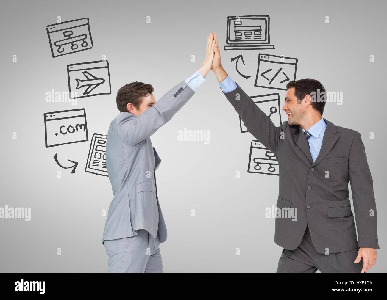Digital composite of Businessmen high five with technology screens ...