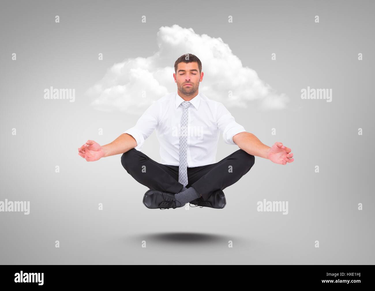 Digital composite of Businessman Meditating floating with cloud against ...