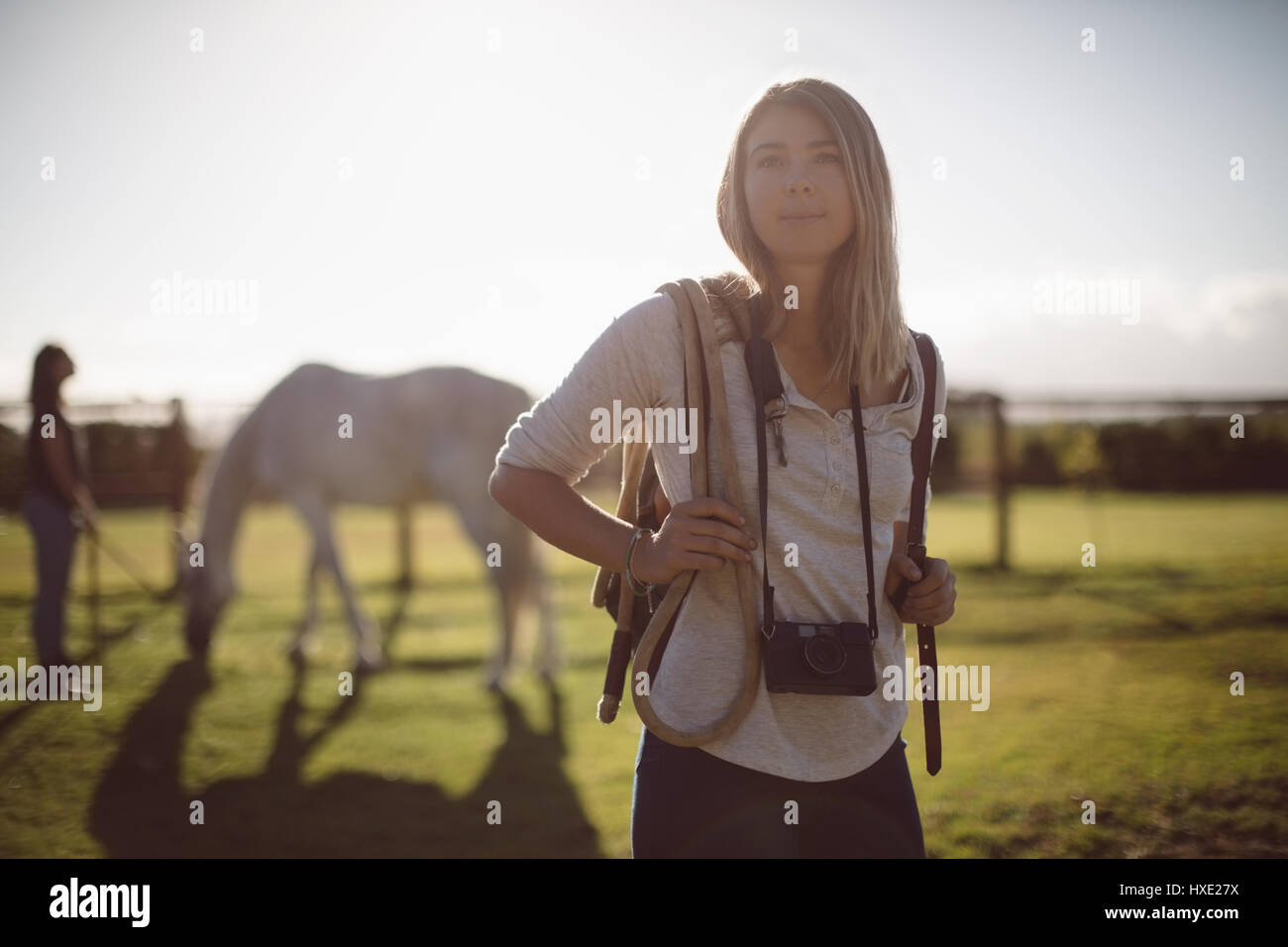 Beautiful woman with backpack and camera Stock Photo - Alamy