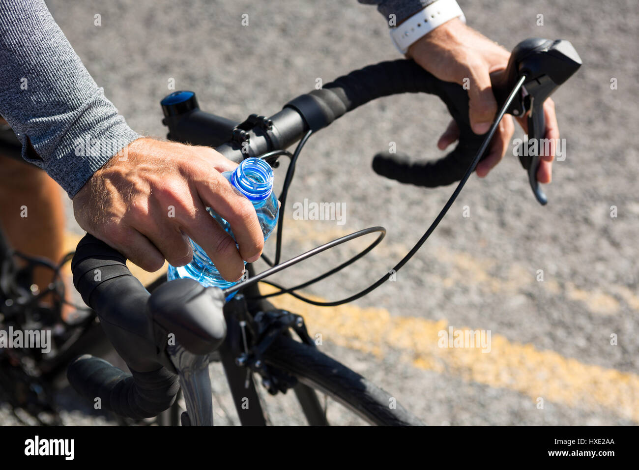 Cropped hand of athlete cycling on road Stock Photo - Alamy
