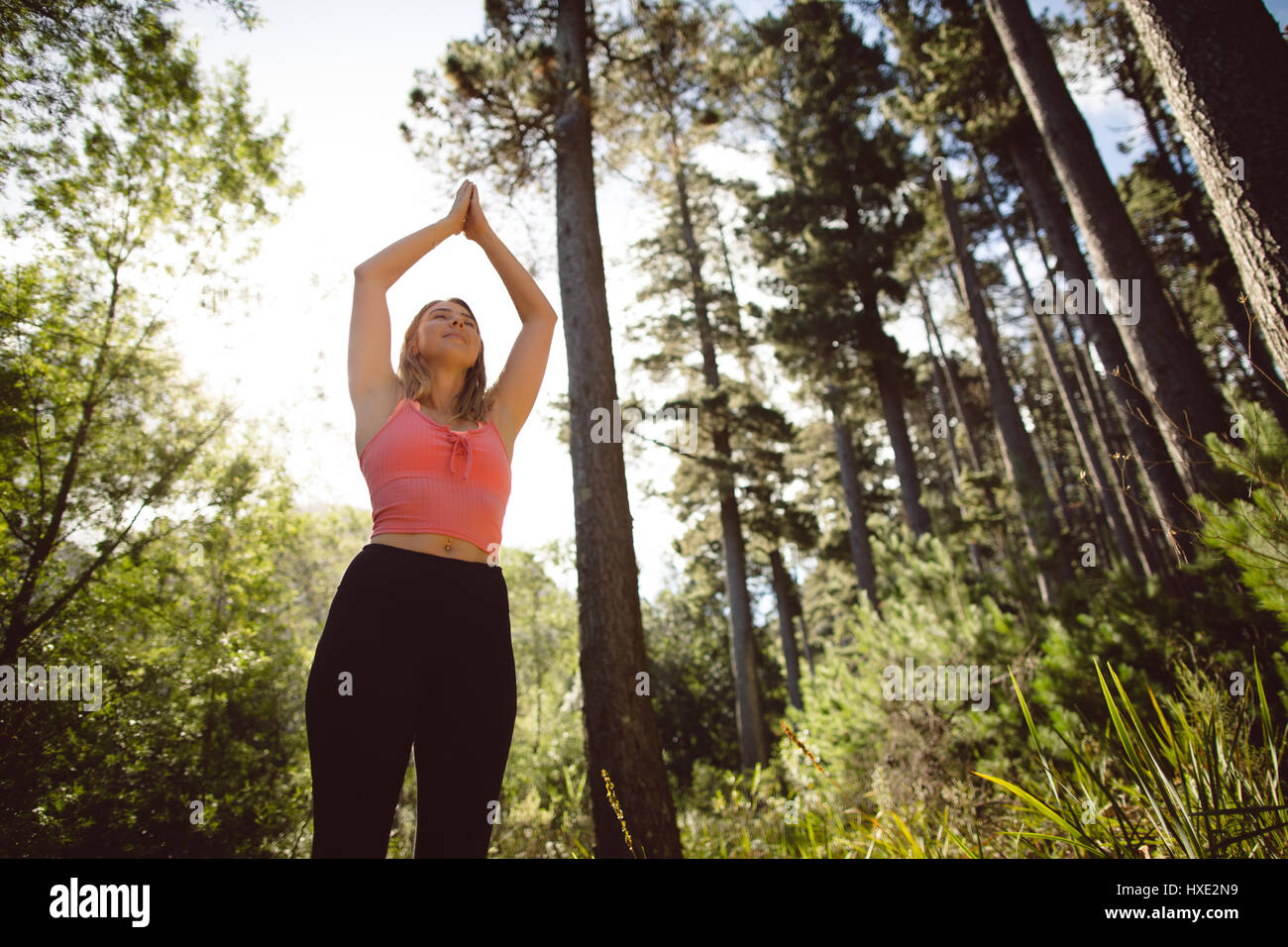 Beautiful woman performing yoga in the forest Stock Photo - Alamy