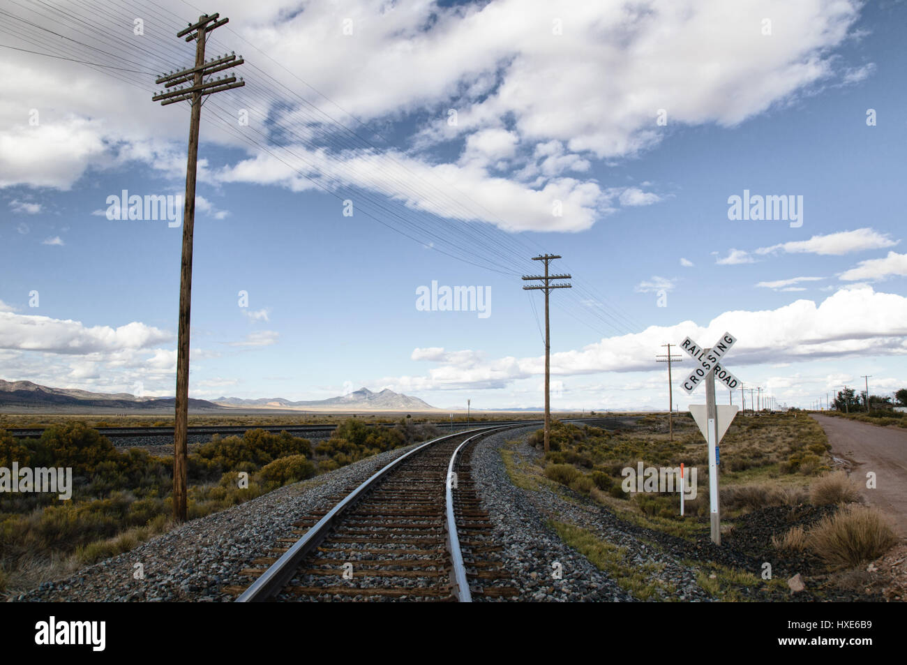 A railroad crossing sign stands next to the railroad tracks in Beryl ...