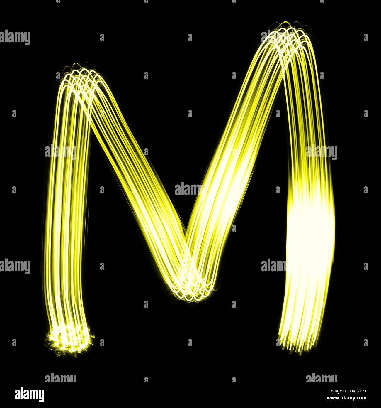 M - Created by light alphabet over black background Stock Photo - Alamy