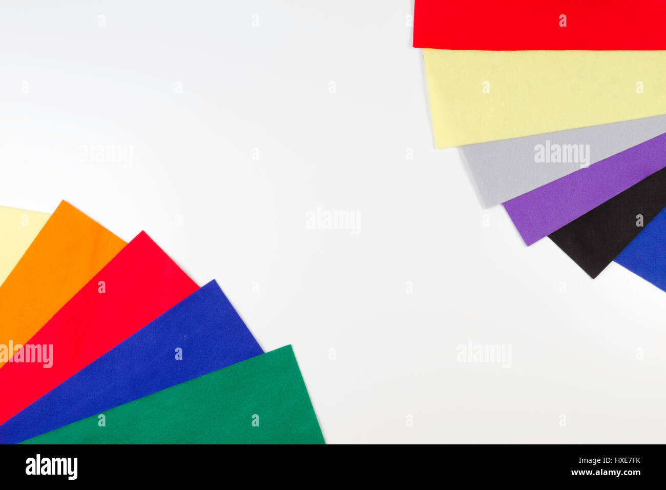 Selection of colorful felt sheets arranged as border frame on white ...