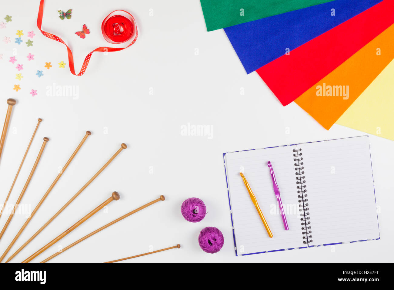 Handicraft background. Knitting, sewing and crochet tools with paper ...