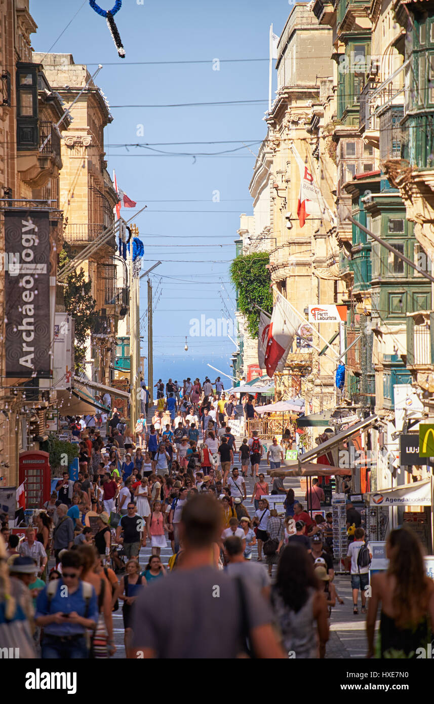 Valletta, MALTA - JULY 24, 2015: A tourist crowd walking along the ...