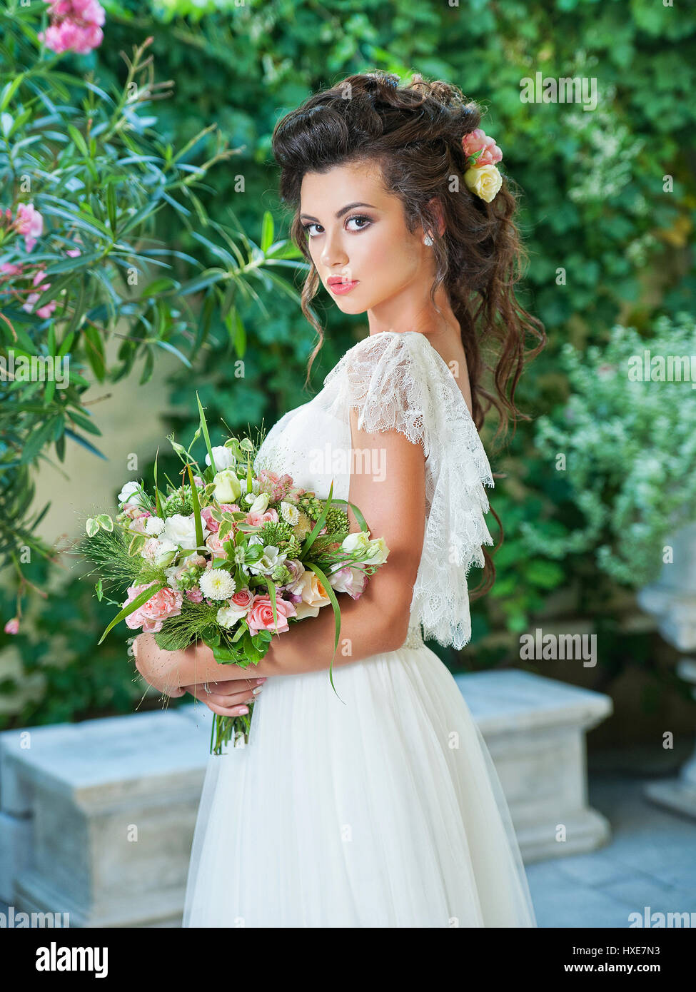 Tender beautiful bride with a bouquet Stock Photo - Alamy