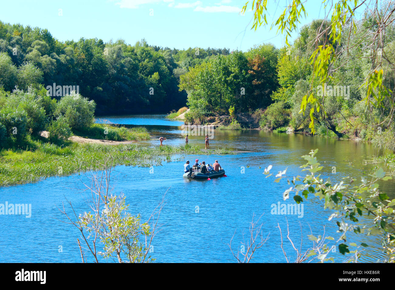 beautiful landscape with river and canoe with people on it Stock Photo ...