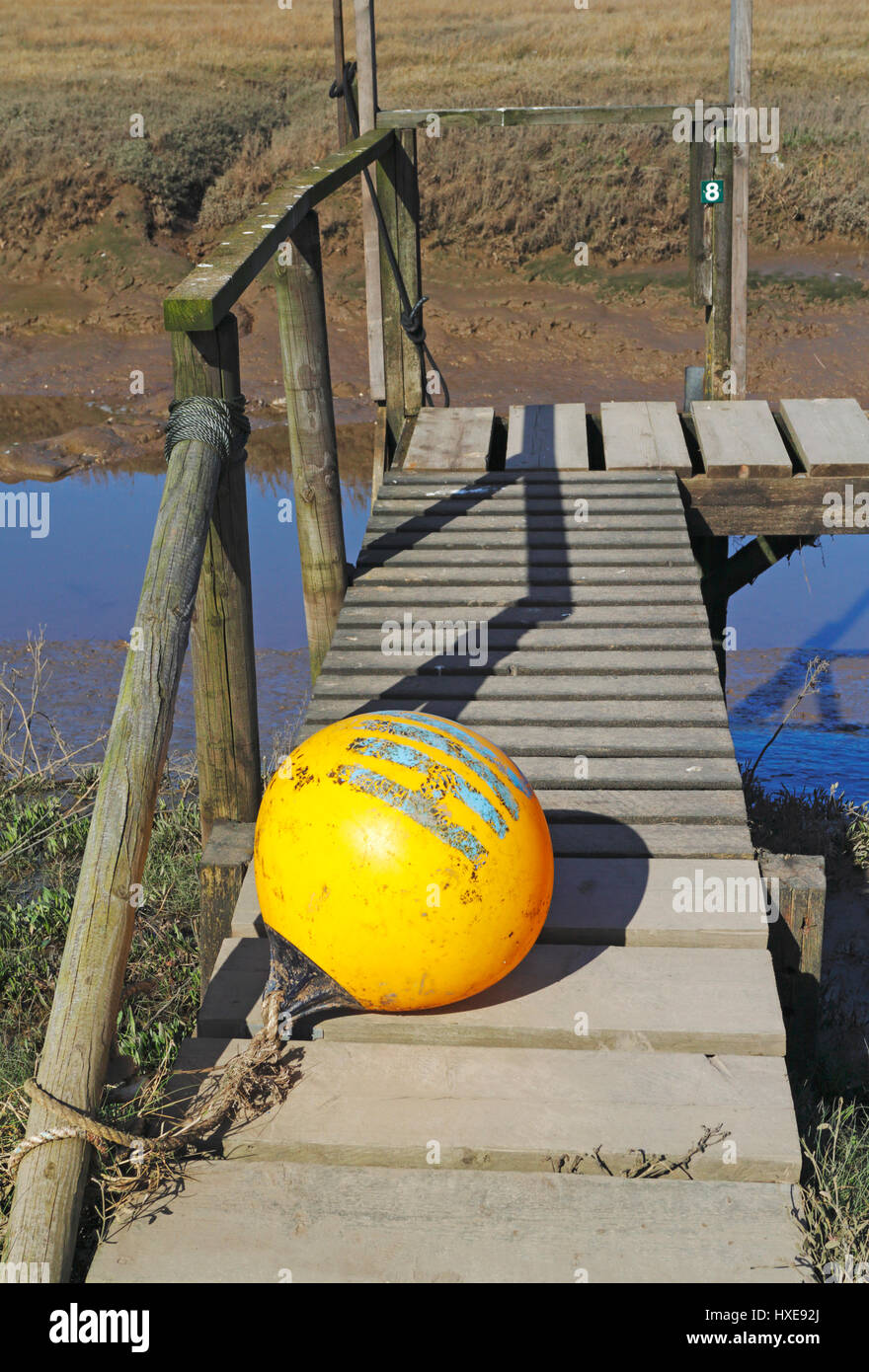 A yellow fishing marker buoy and quay staging at Thornham, Norfolk ...