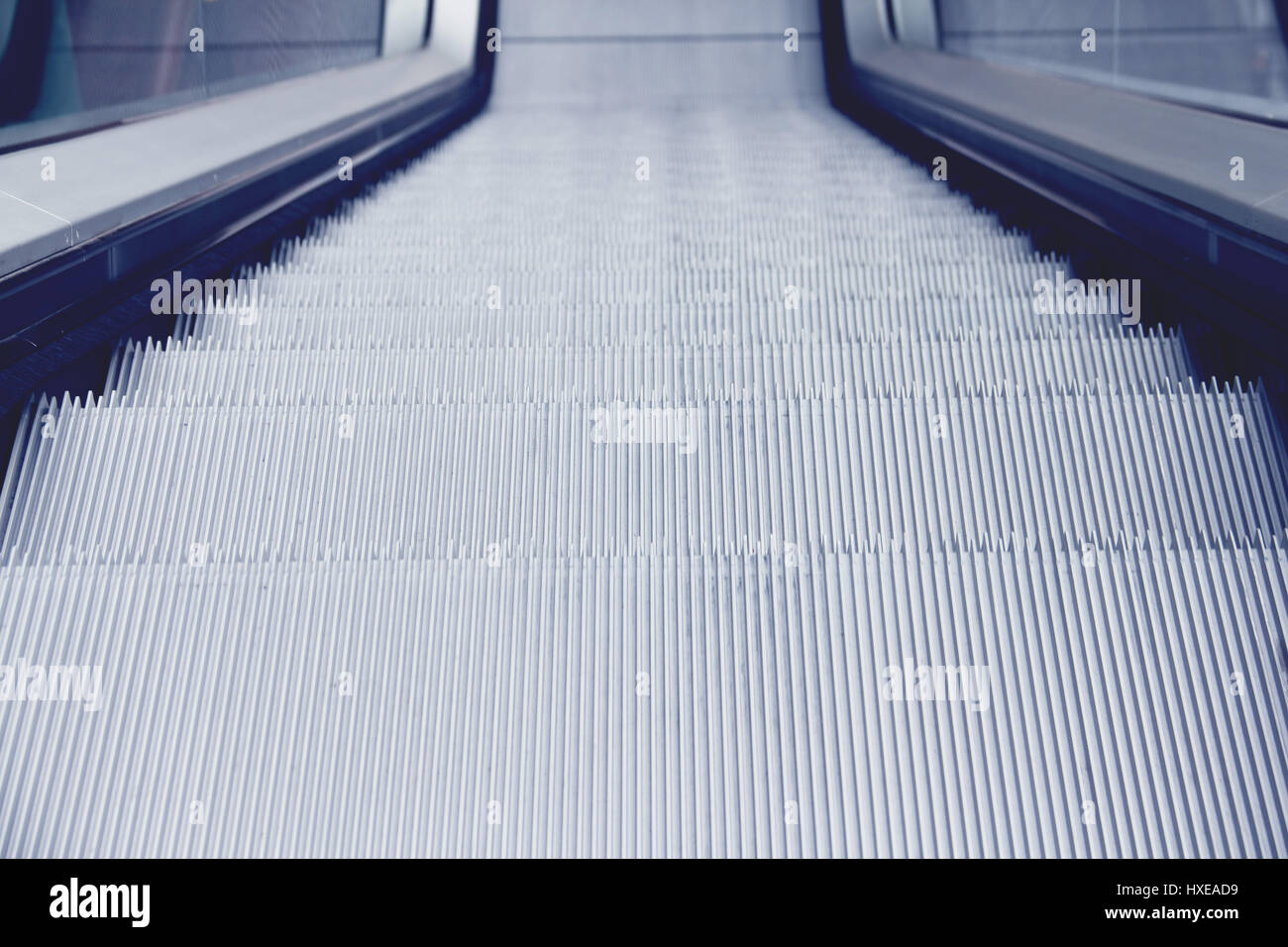 View on Escalator steps perspective inside building Stock Photo - Alamy