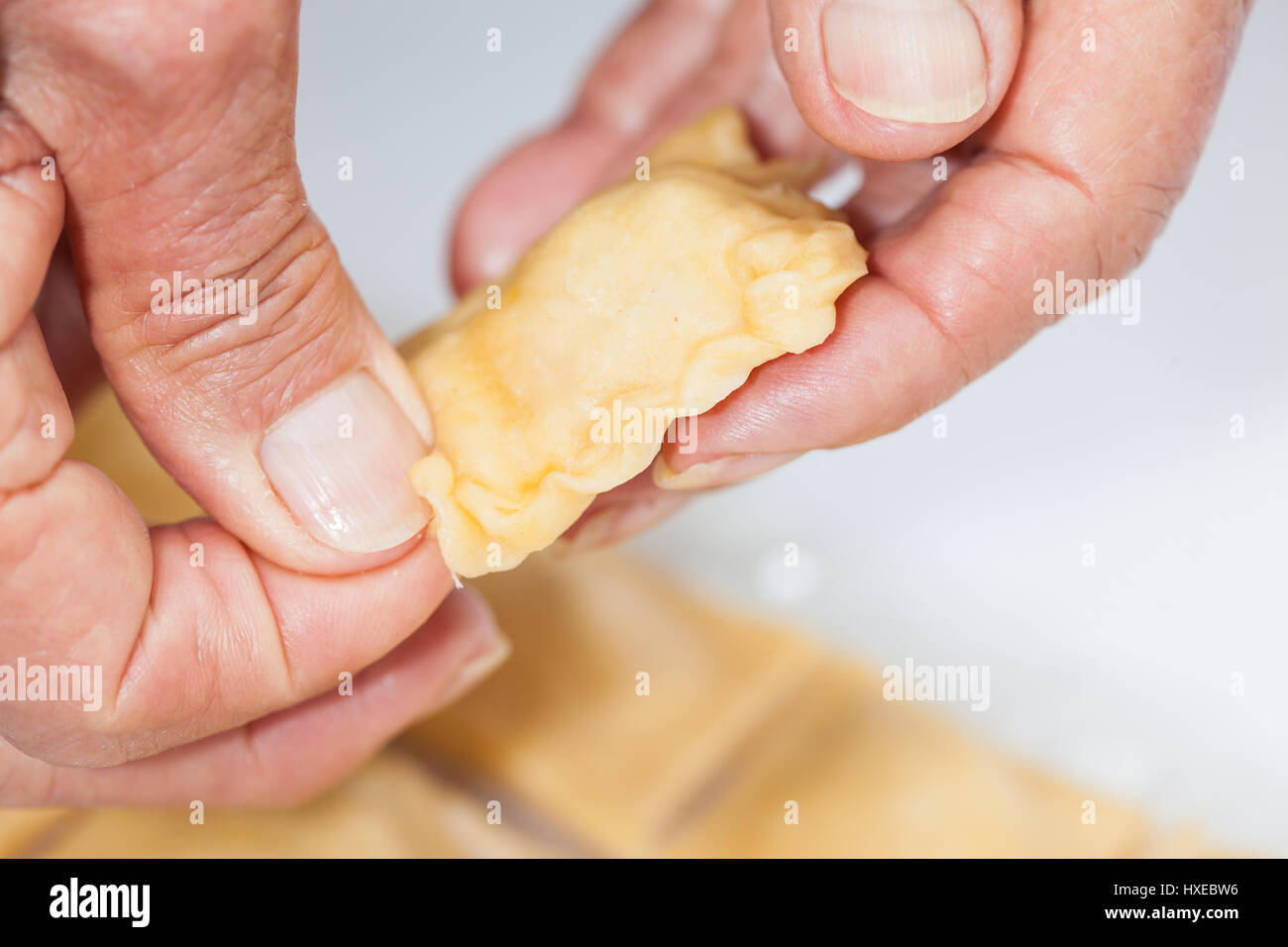 Ravioli Preparation : Sealing and decorating raw cut ravioli edge Stock ...