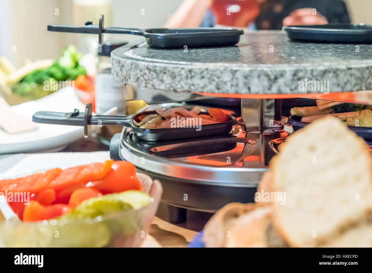 View of Family table for cooking on Raclette Stock Photo - Alamy