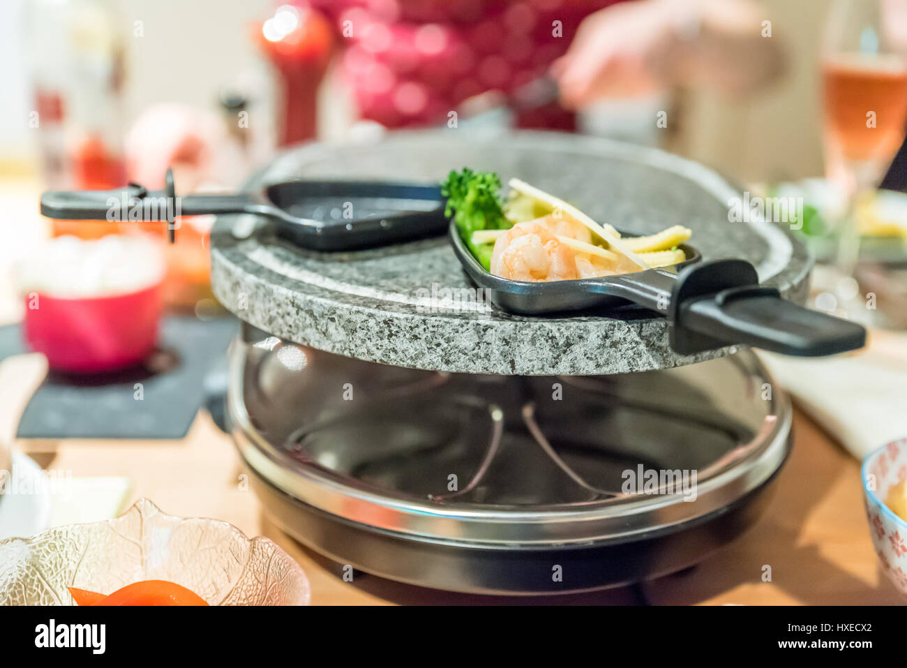 View of Family table for cooking on Raclette Stock Photo - Alamy