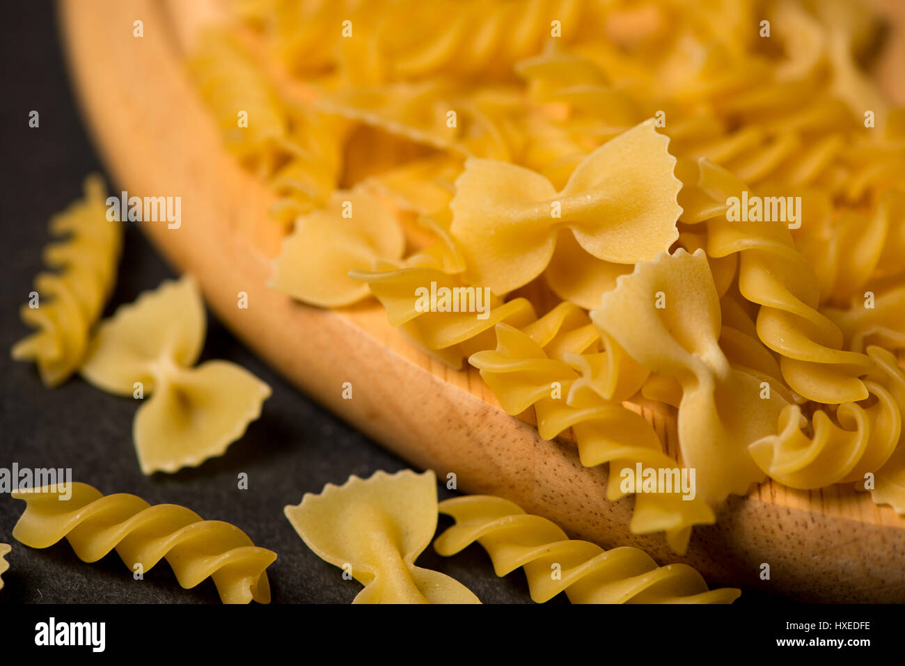 Variety of types and shapes of dry Italian pasta on dark background ...