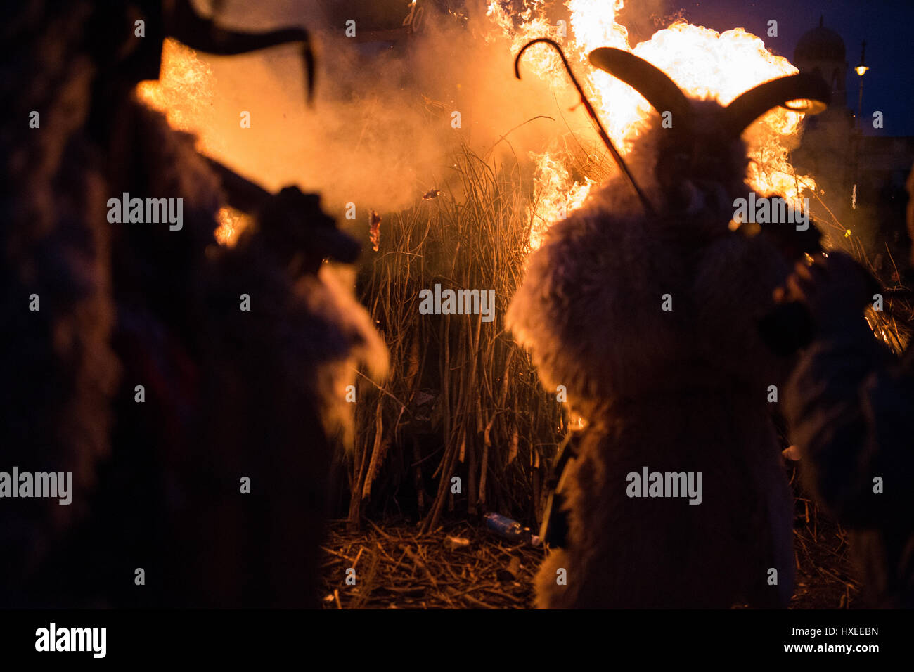 Busós standing in front of the huge bonfire lit on the main square of ...