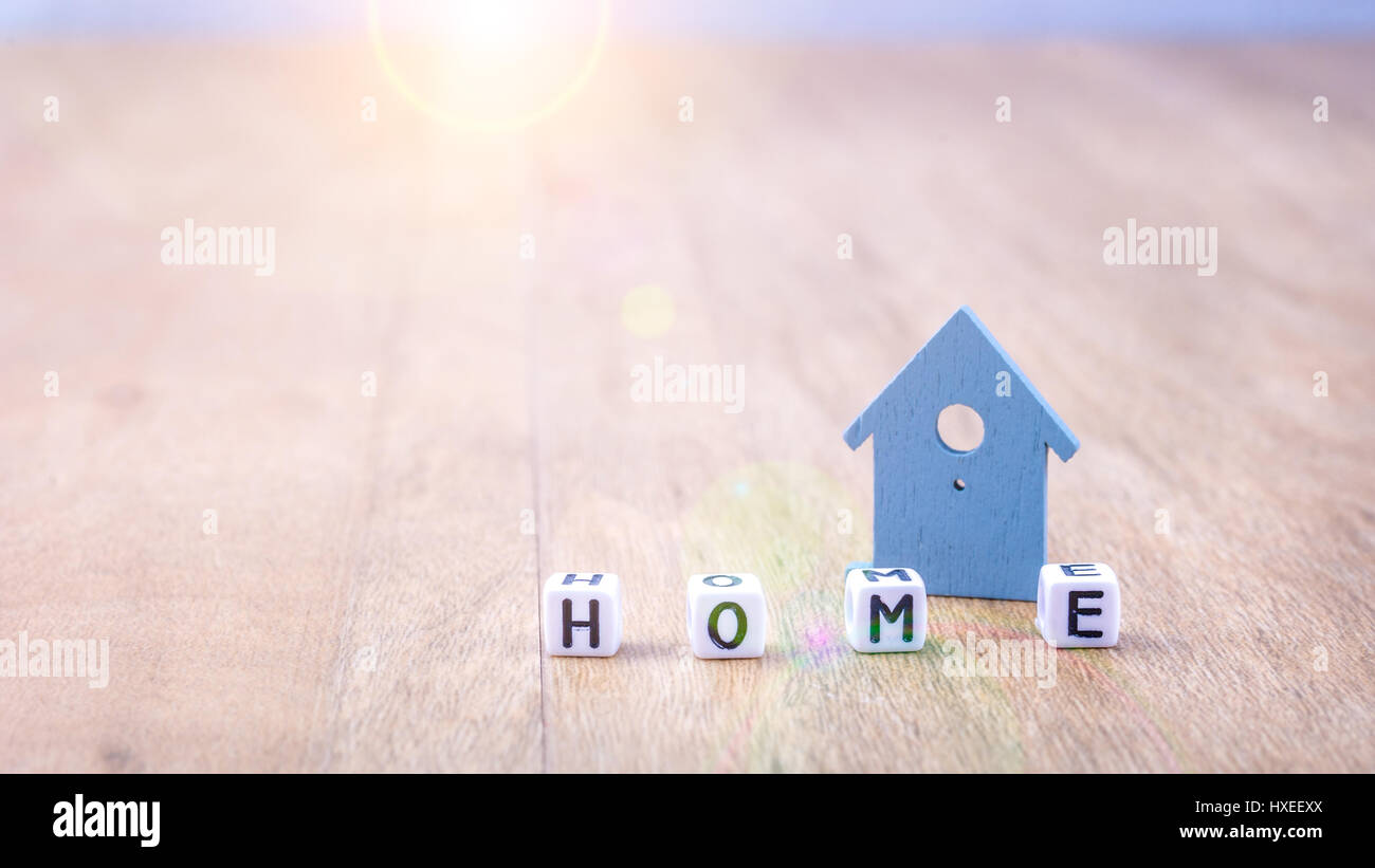 HOME word of cube letters in front of blue coloured house symbol on ...