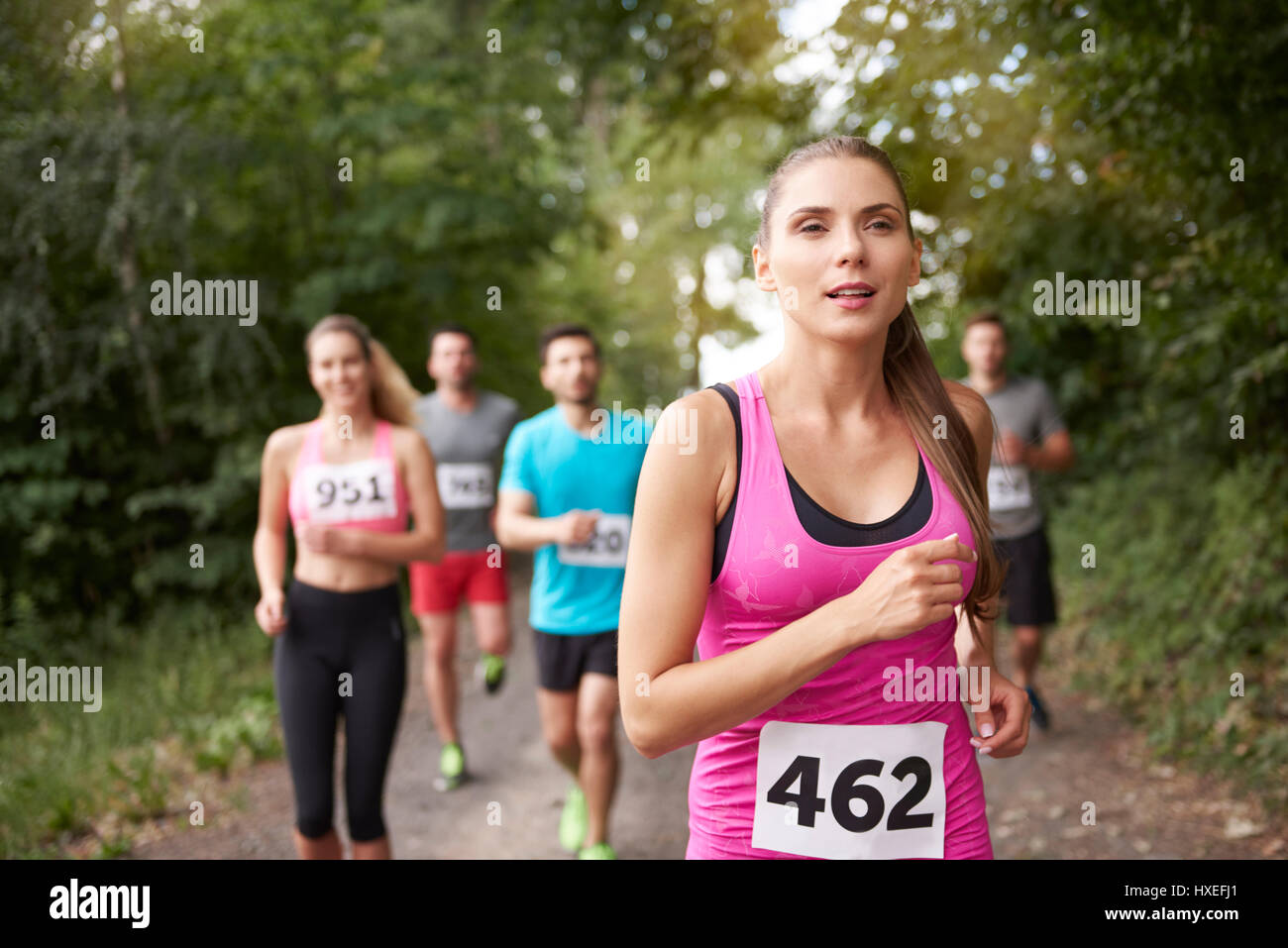 Woman leading in the running marathon Stock Photo - Alamy