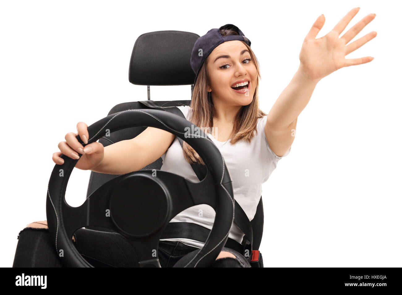 Joyful teen driver waving at the camera isolated on white background ...