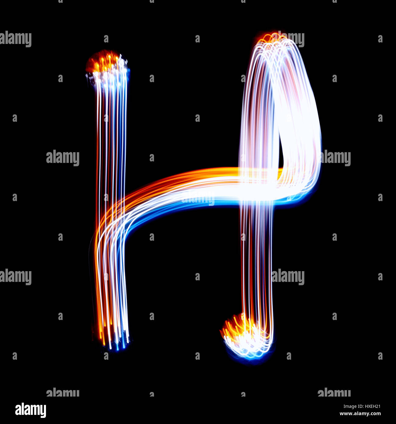 H - Created by light colorful letters over black background Stock Photo ...