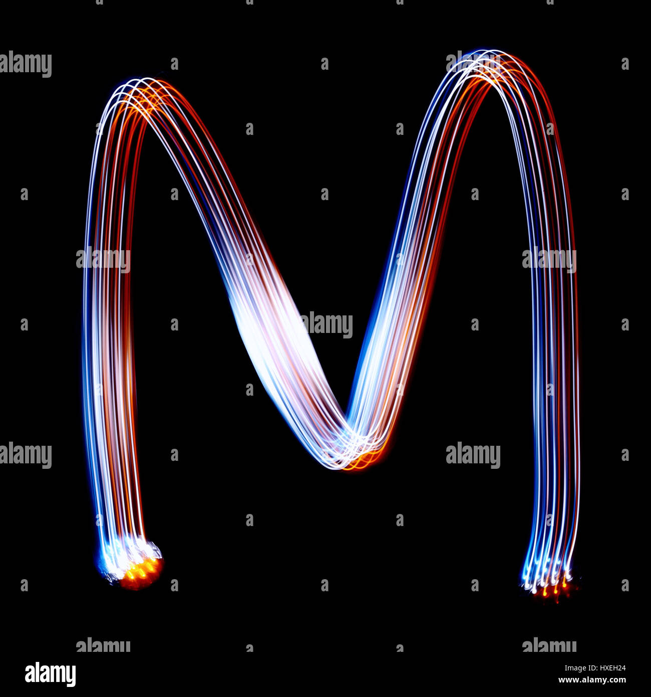 M - Created by light colorful letters over black background Stock Photo ...