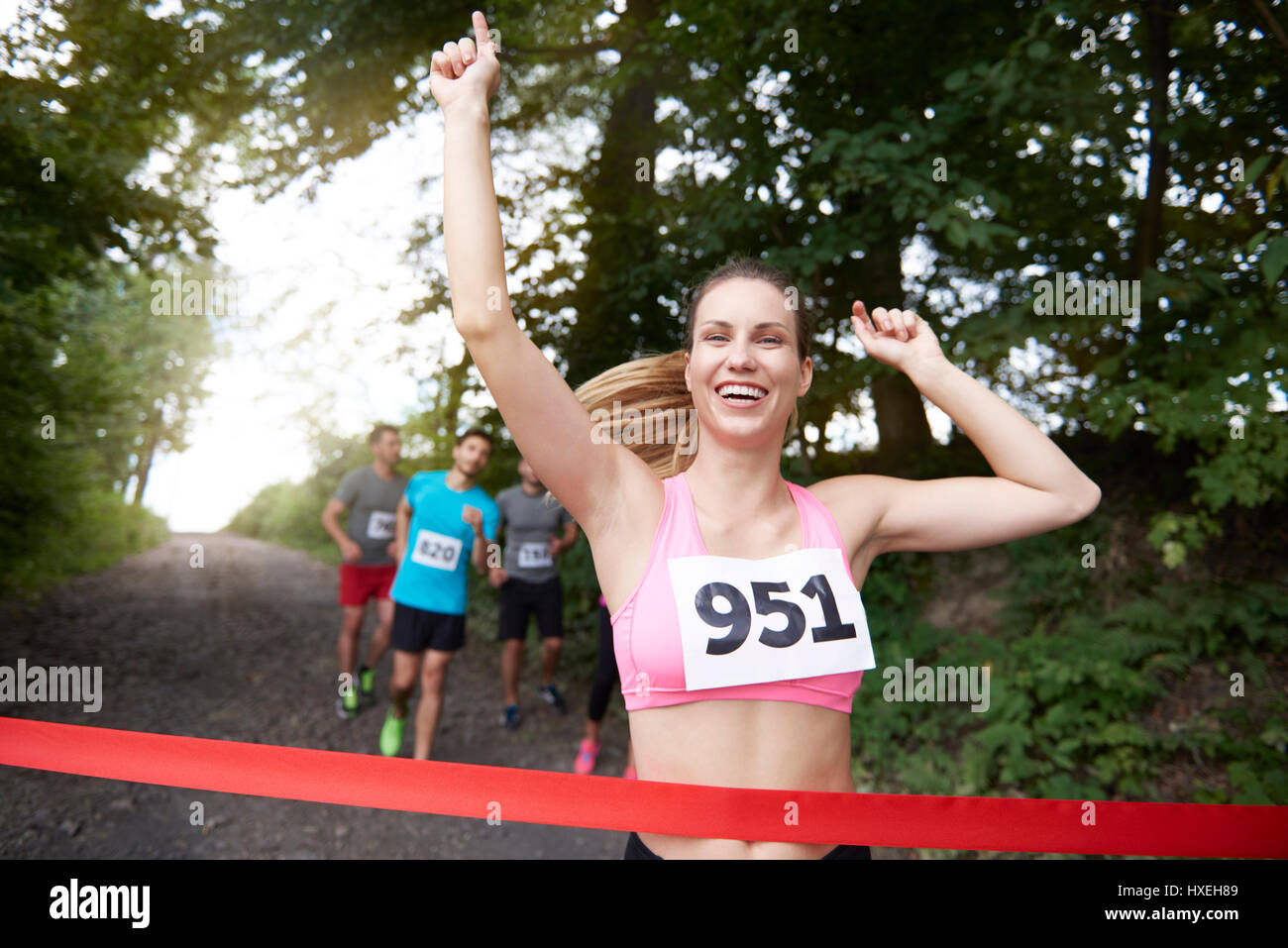 Woman first on the finishing line Stock Photo - Alamy