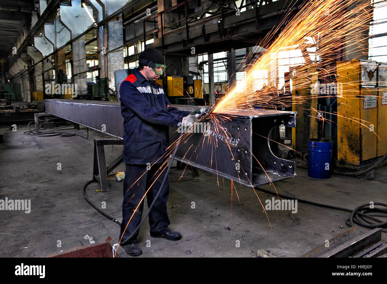 St. Petersburg, Russia - May 18, 2015: Metalworker grinds weld seam ...
