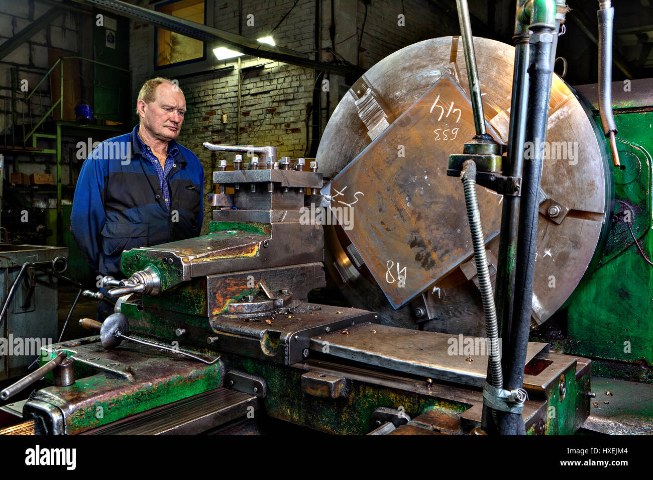 St. Petersburg, Russia - May 21, 2015: Master turner machine operator ...