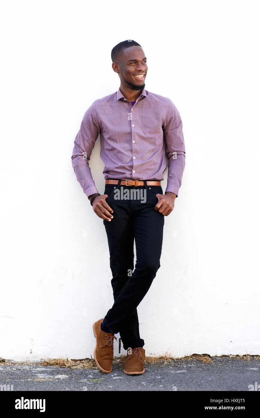 Full length portrait of a handsome young african guy standing against white background Stock ...