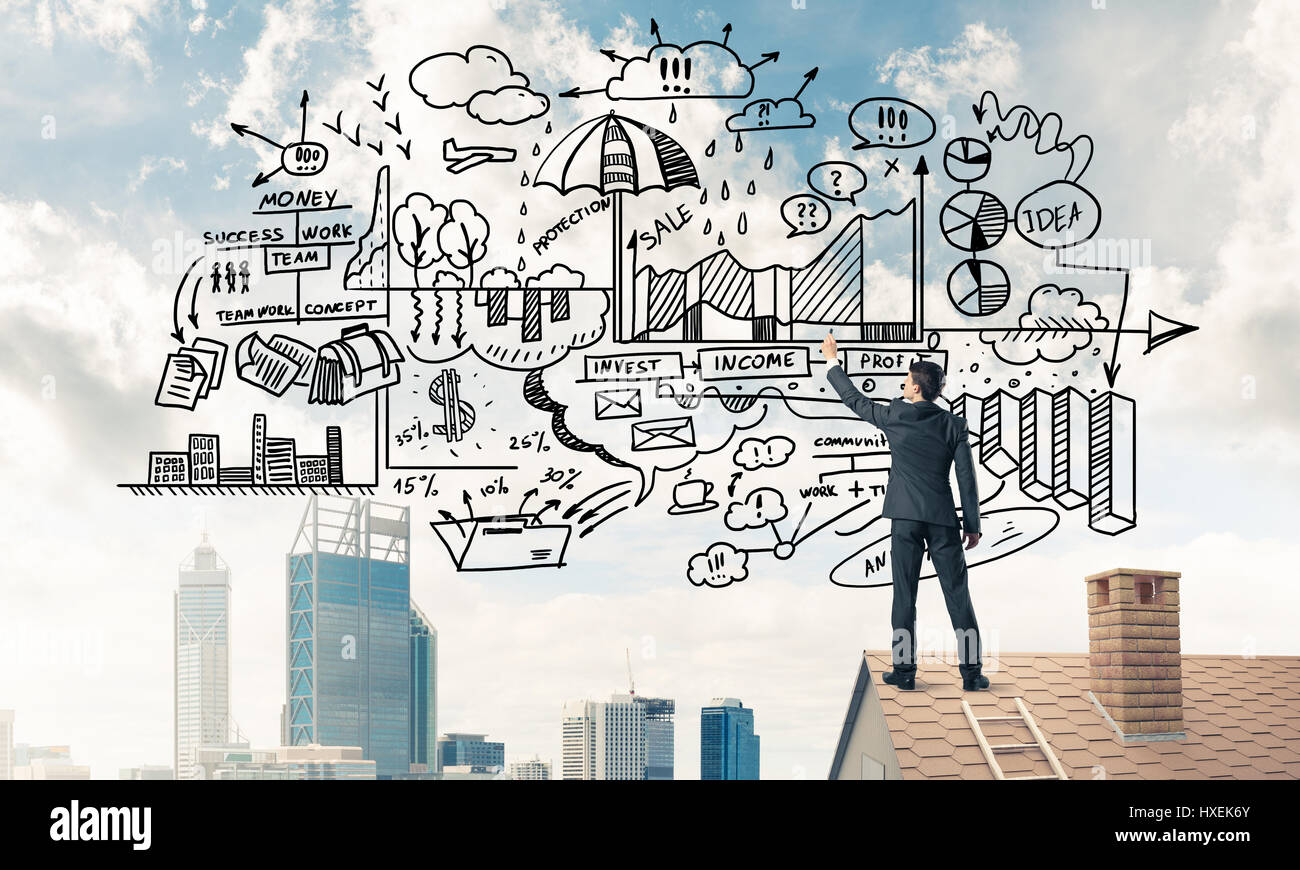 Rear view of businessman on house roof drawing his new business Stock ...