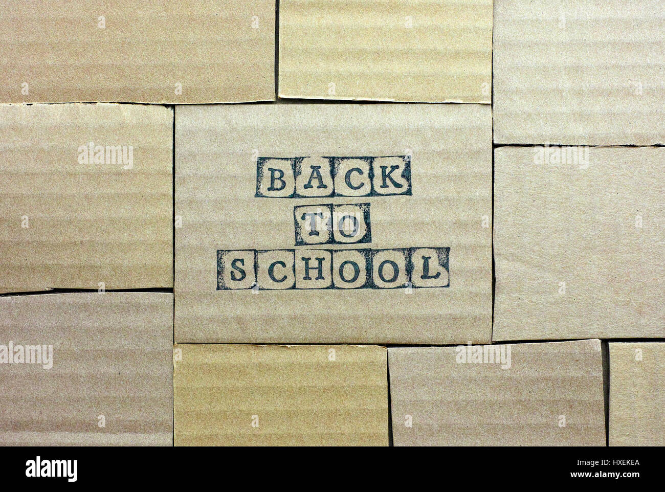 Cardboard card with words Back to School made by black alphabet stamps ...