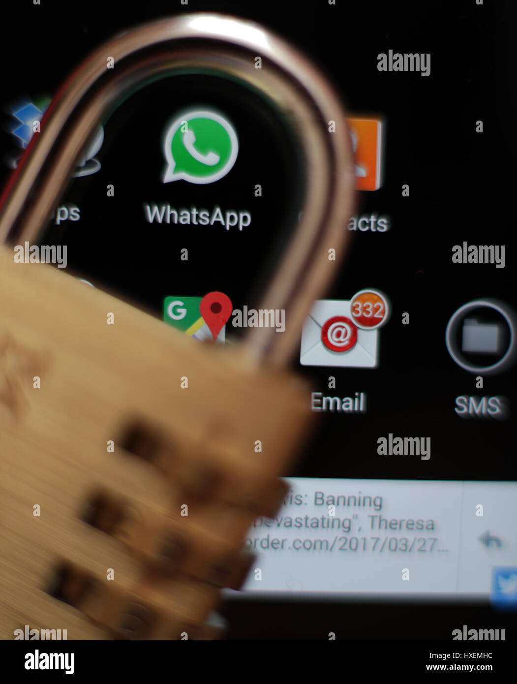 A combination padlock is placed next to the WhatsApp icon on the screen ...