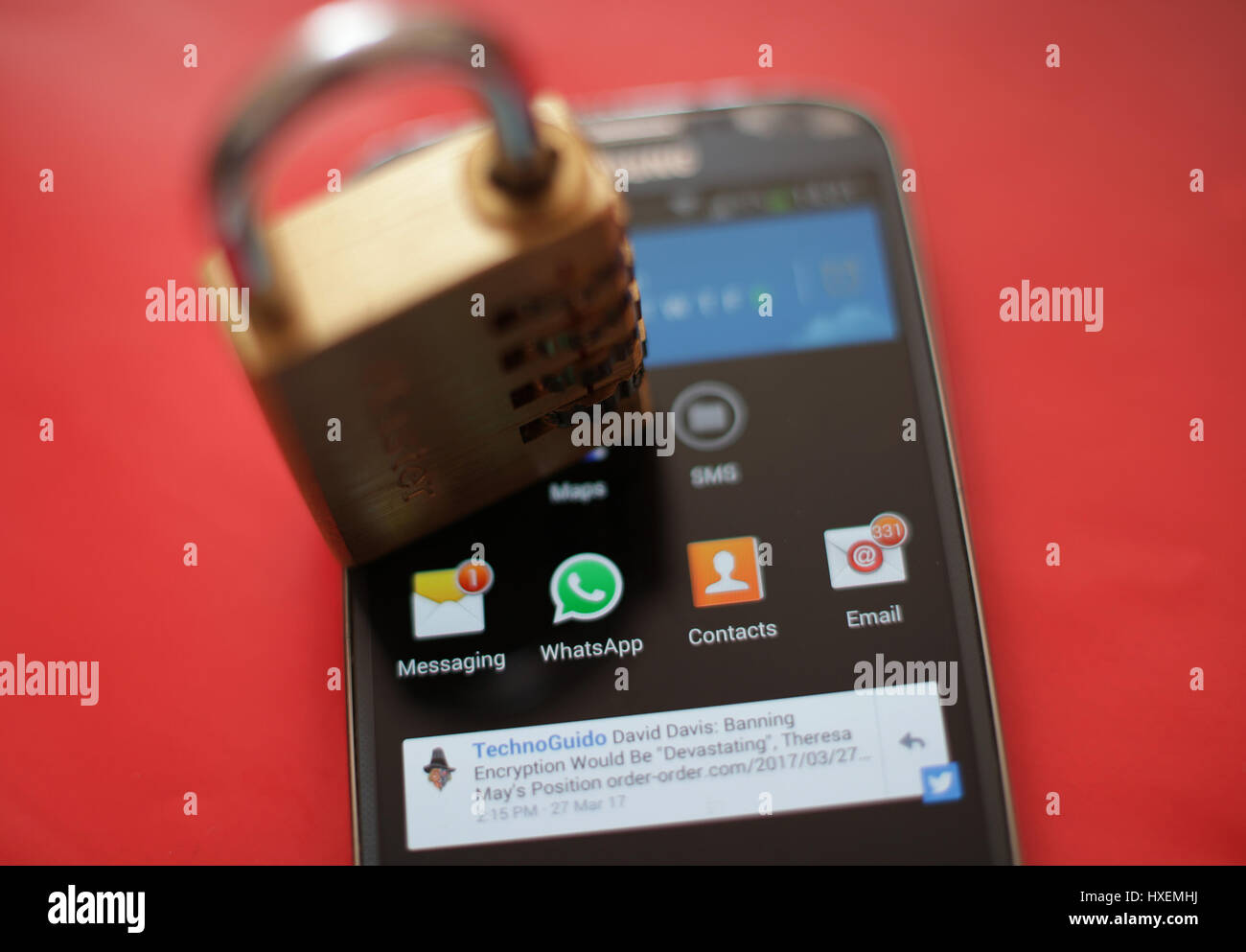 A combination padlock is placed next to the WhatsApp icon on the screen ...