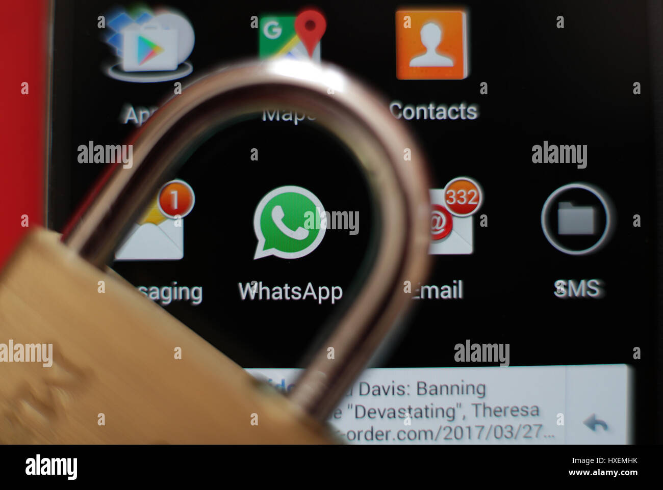 A combination padlock is placed next to the WhatsApp icon on the screen ...