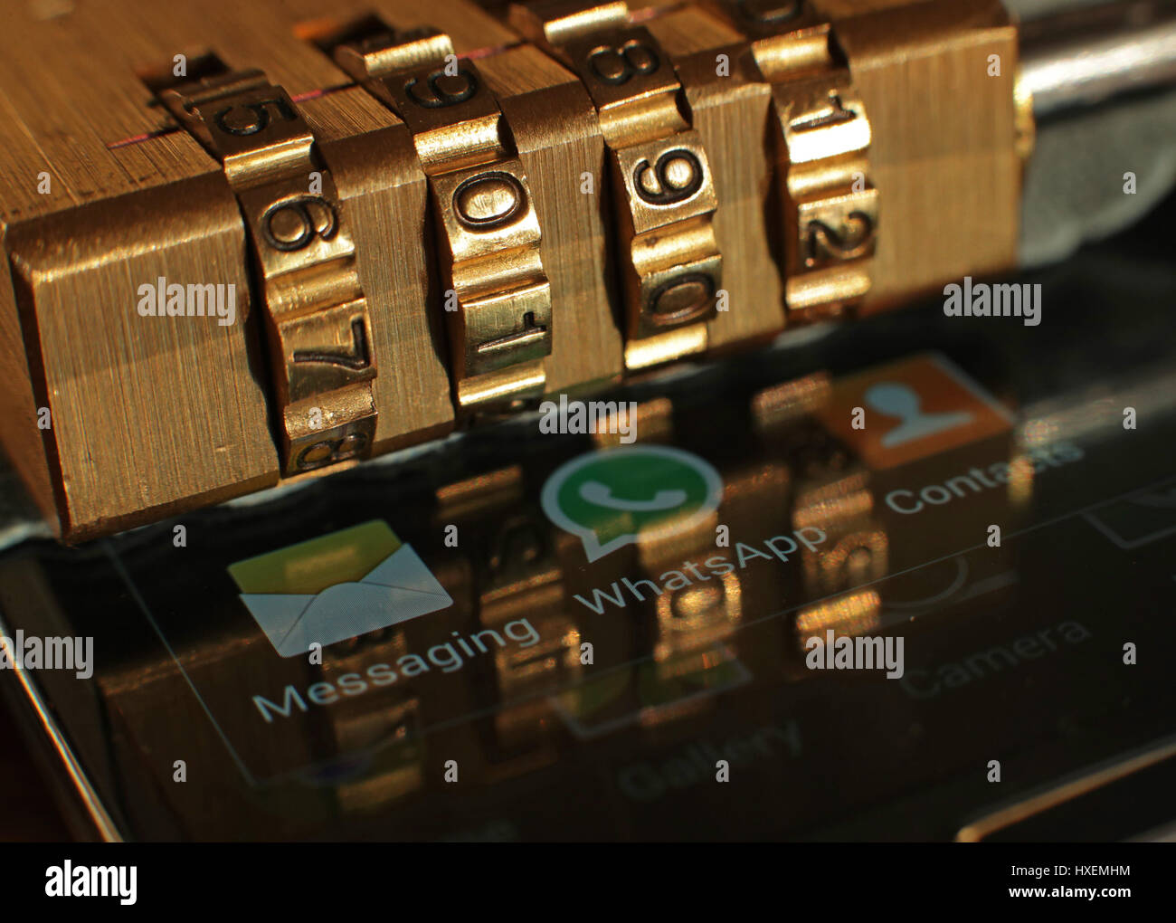 A combination padlock is placed next to the WhatsApp icon on the screen ...