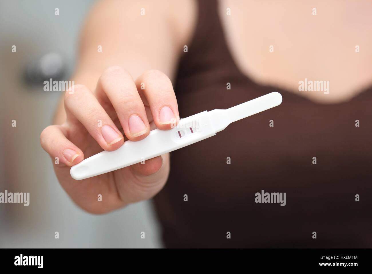positive pregnancy test shown by young female Stock Photo - Alamy