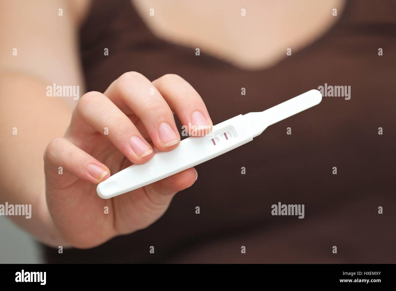 positive pregnancy test shown by young female Stock Photo - Alamy