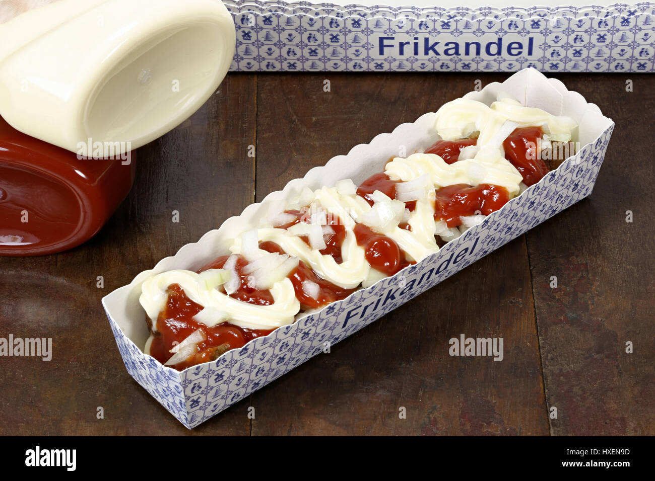 traditional Dutch frikandel special in a cardboard container on wooden ...