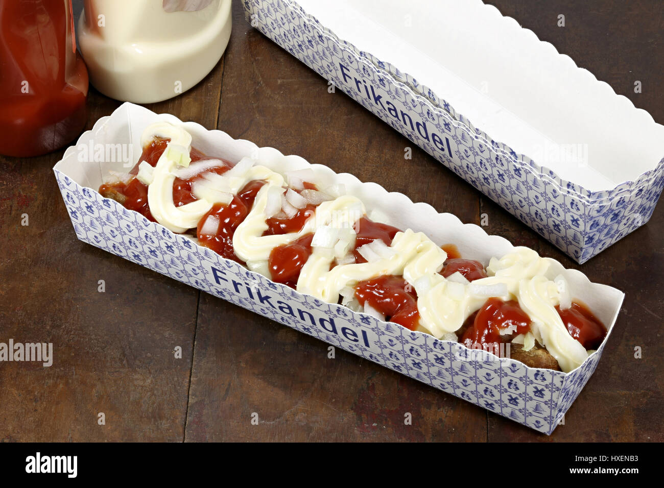 traditional Dutch frikandel special in a cardboard container on wooden ...