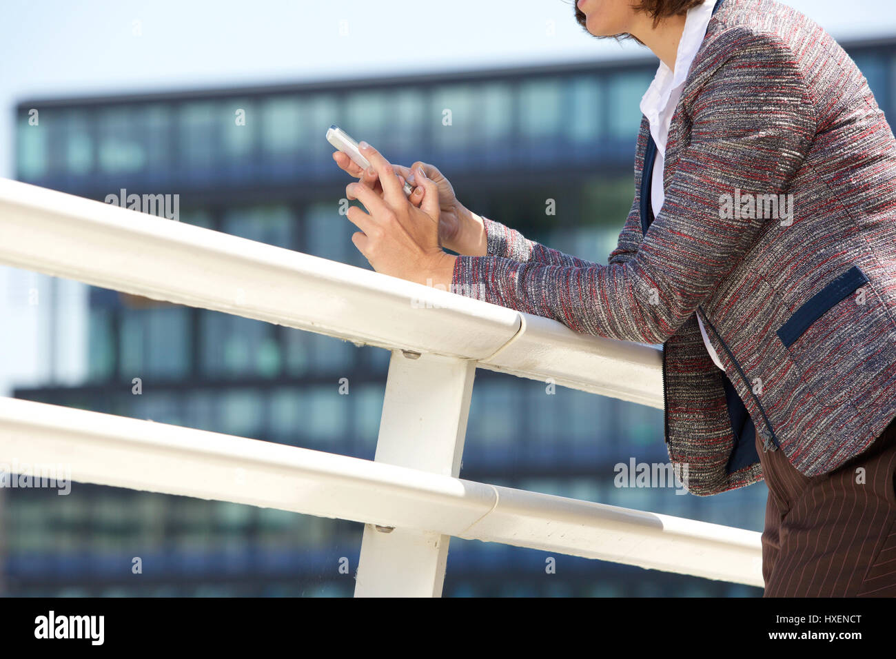 Close up female hands using mobile phone outside Stock Photo - Alamy