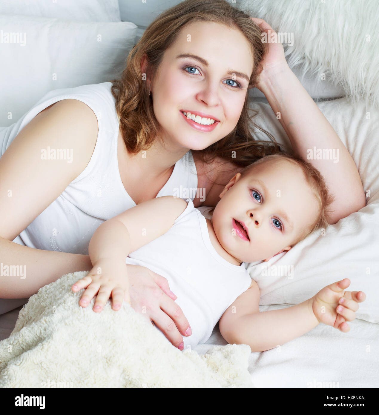 Happy Beautiful Mother With Her One Year Old Son Studio Shot Stock happy-beautiful-mother-with-her-one-year-old-son-studio-shot-stock