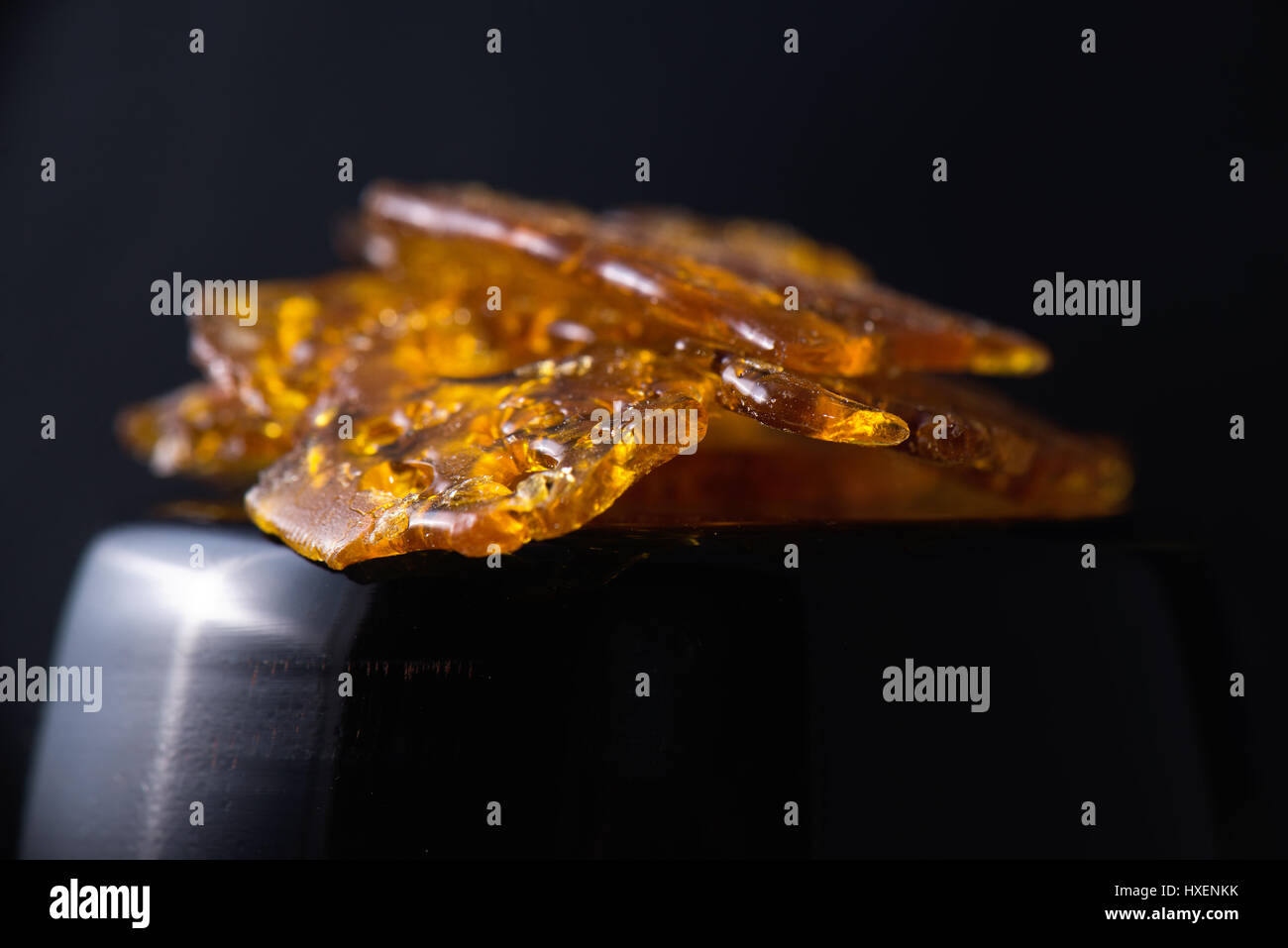 Close up detail of marijuana oil concentrate aka shatter isolated on ...