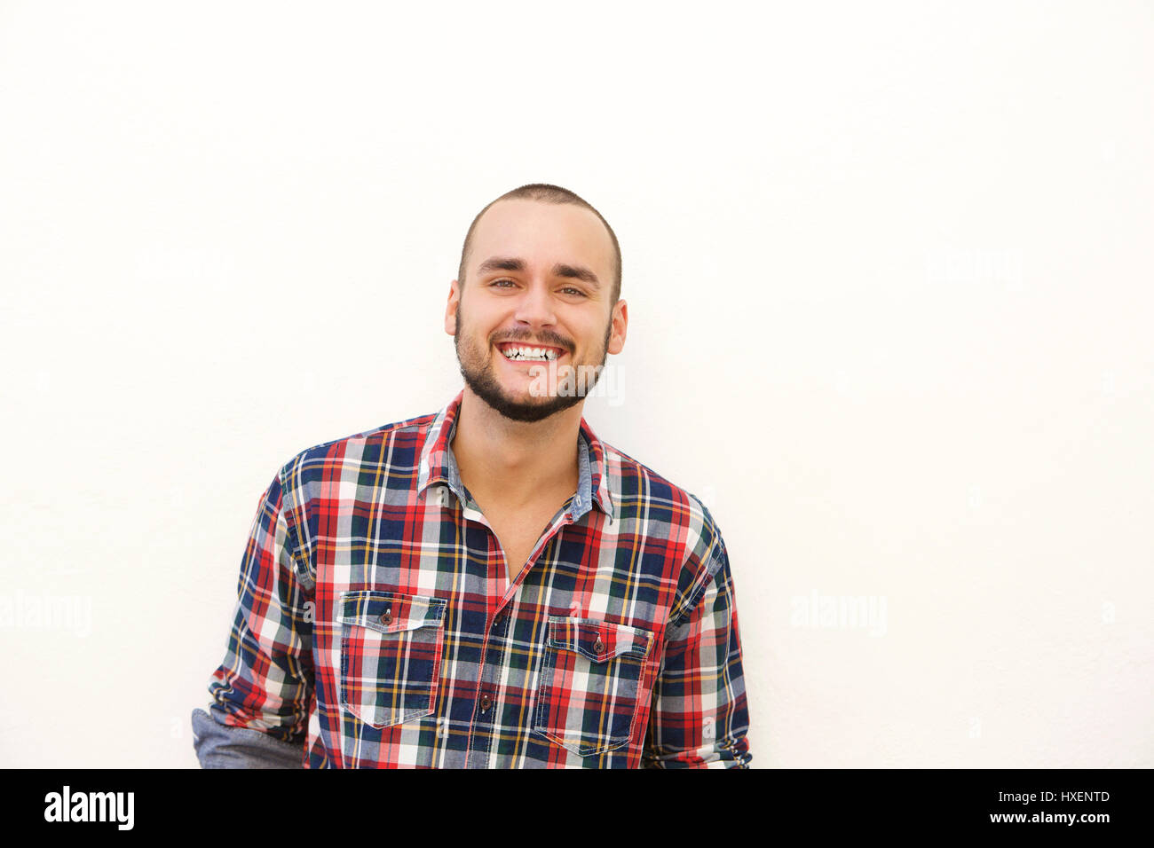 Close up happy hispanic guy in plaid shirt smiling against white ...