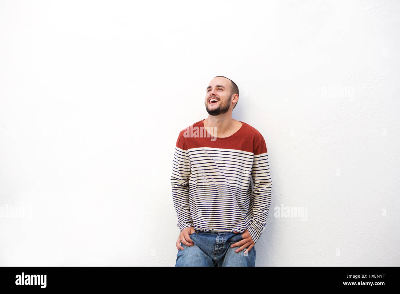 Portrait of a cool young man laughing against white background Stock ...