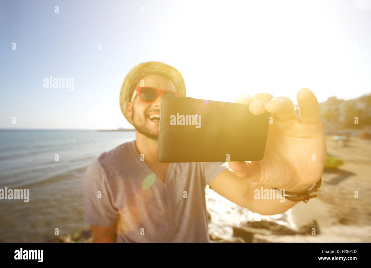 Happy man on vacation taking a selfie at the beach Stock Photo - Alamy