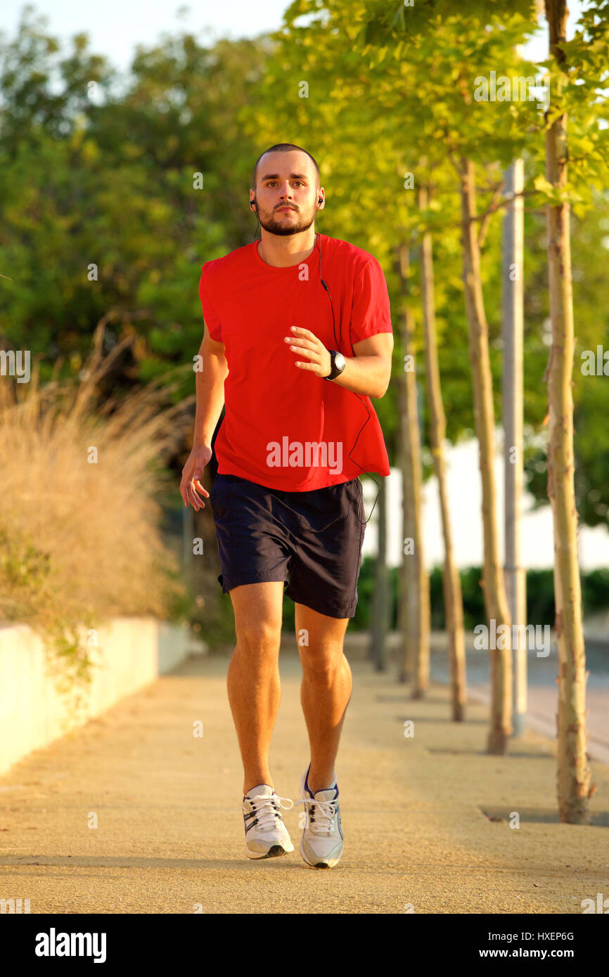 Full body healthy young man running outdoors Stock Photo - Alamy