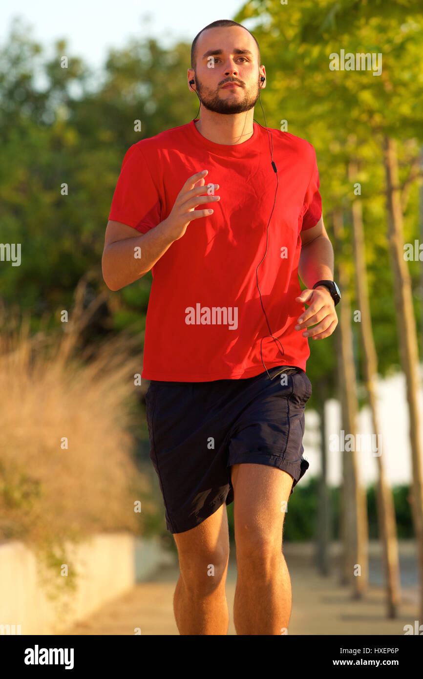 Young active man enjoying a jog outdoors Stock Photo - Alamy