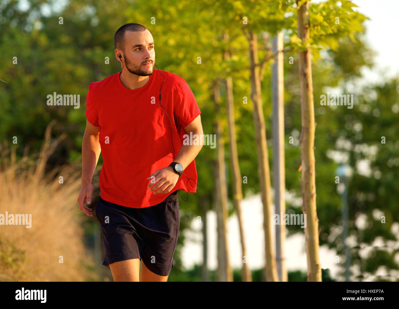 Young man exercise running outdoors keeping fit Stock Photo - Alamy