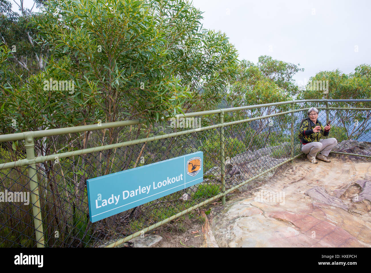 Lady crouching down at Lady Darley lookout in Katoomba,blue mountains ...